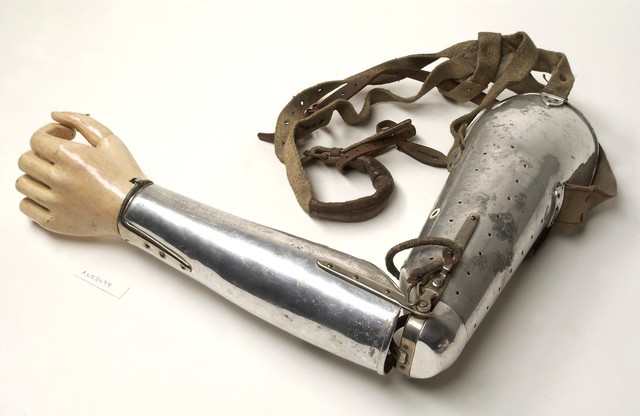 Artificial left arm, metal, with hand and canvas shoulder strap. Made ...