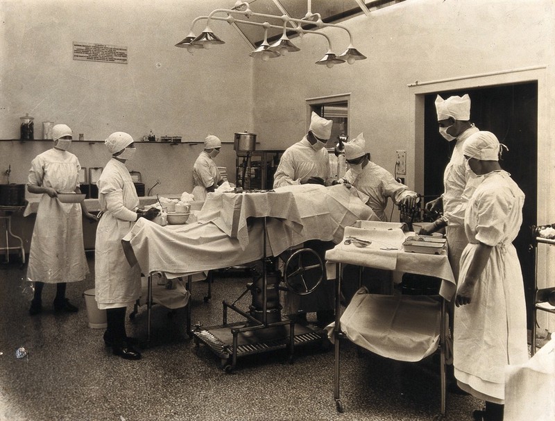An operating theatre: surgical staff performing an operation ...
